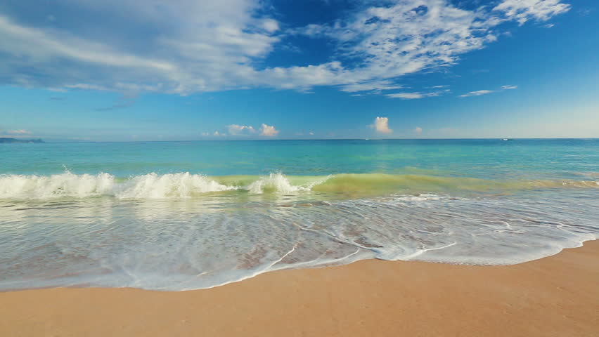 Ocean Waves Crash Into Rocks On The Edge Of A Sandy Beach In 1080 Hd