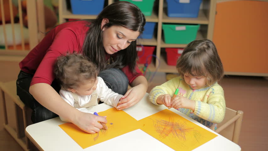 Preschool With Teacher Helping Toddler And 2-3 Year Girl Drawing Stock ...