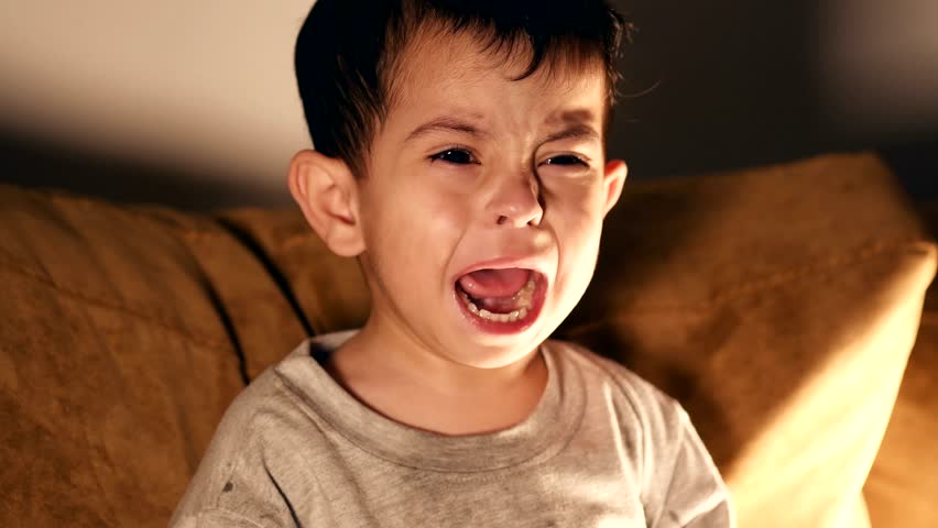 Portrait Of 8 Years Old Boy Crying And Looking At Camerae. Family ...