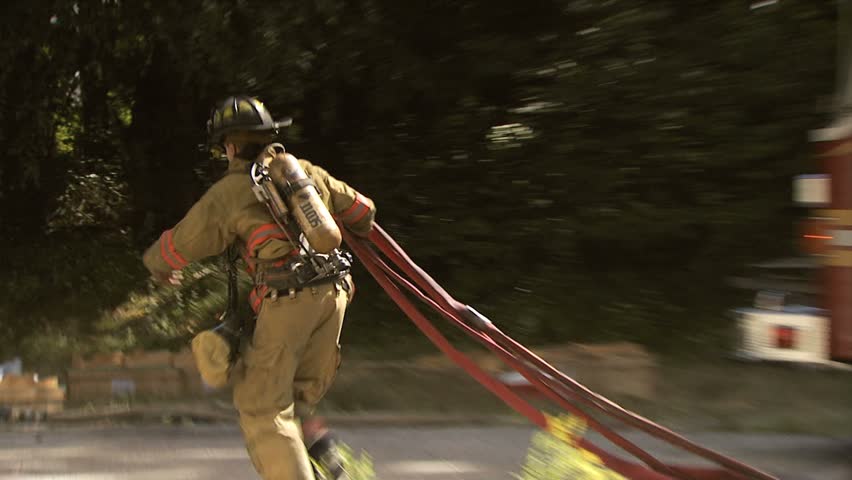 EAST GREENWICH, RHODE ISLAND - CIRCA AUGUST 2010: Fireman Running With ...