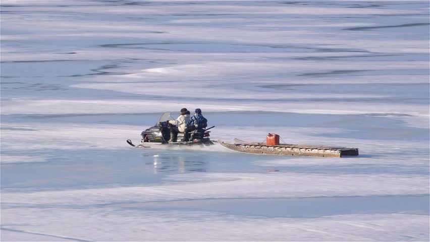 Snowmobile Towing A Qamutik Across Sea-ice In Arctic Bay, Nunavut ...
